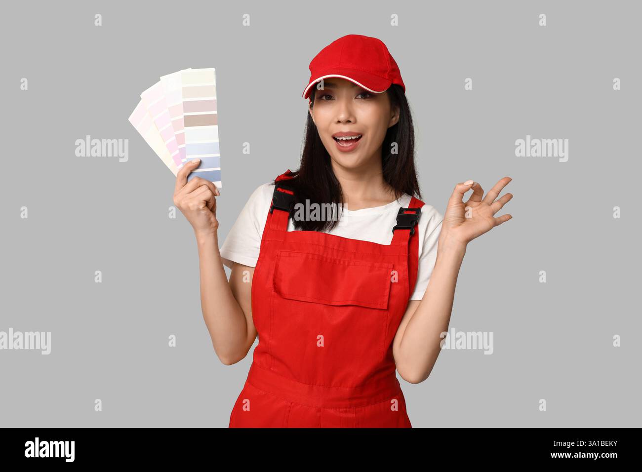 Female Asian painter with paint color palettes showing OK gesture on ...