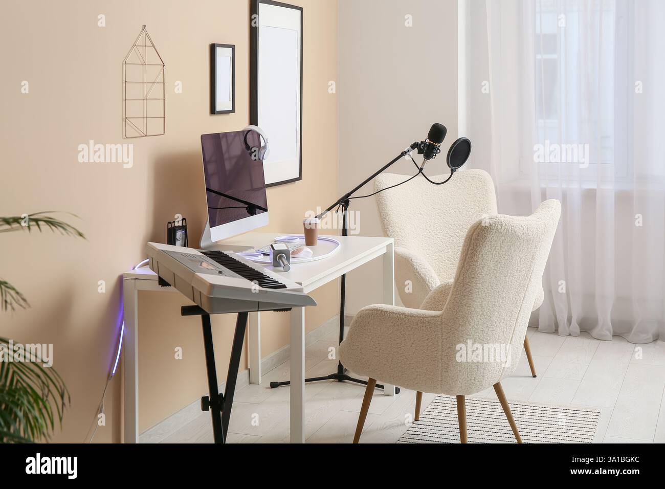 Interior of recording studio with workplace, microphone and synthesizer ...