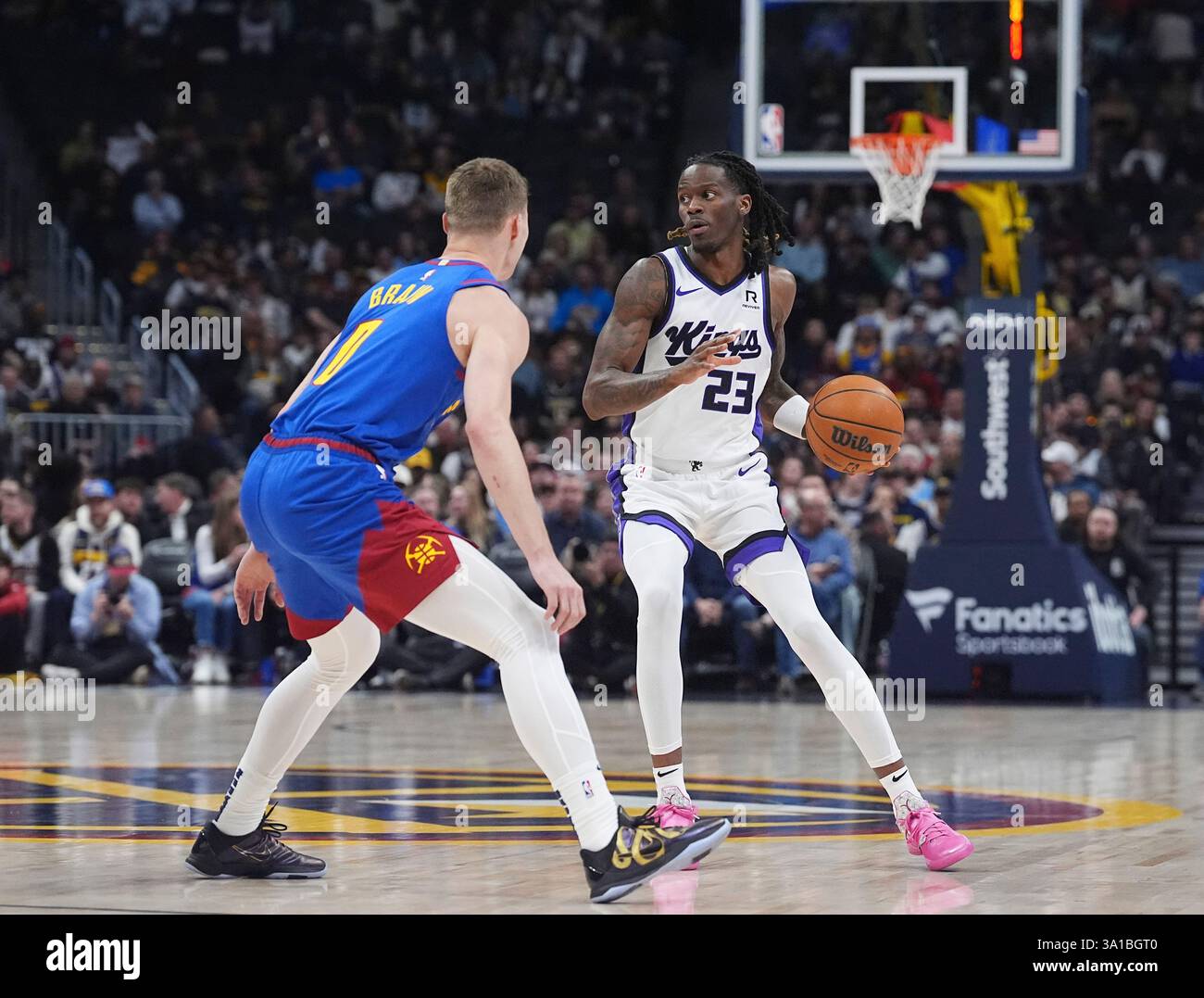 Sacramento Kings guard Keon Ellis (23) and Denver Nuggets guard ...