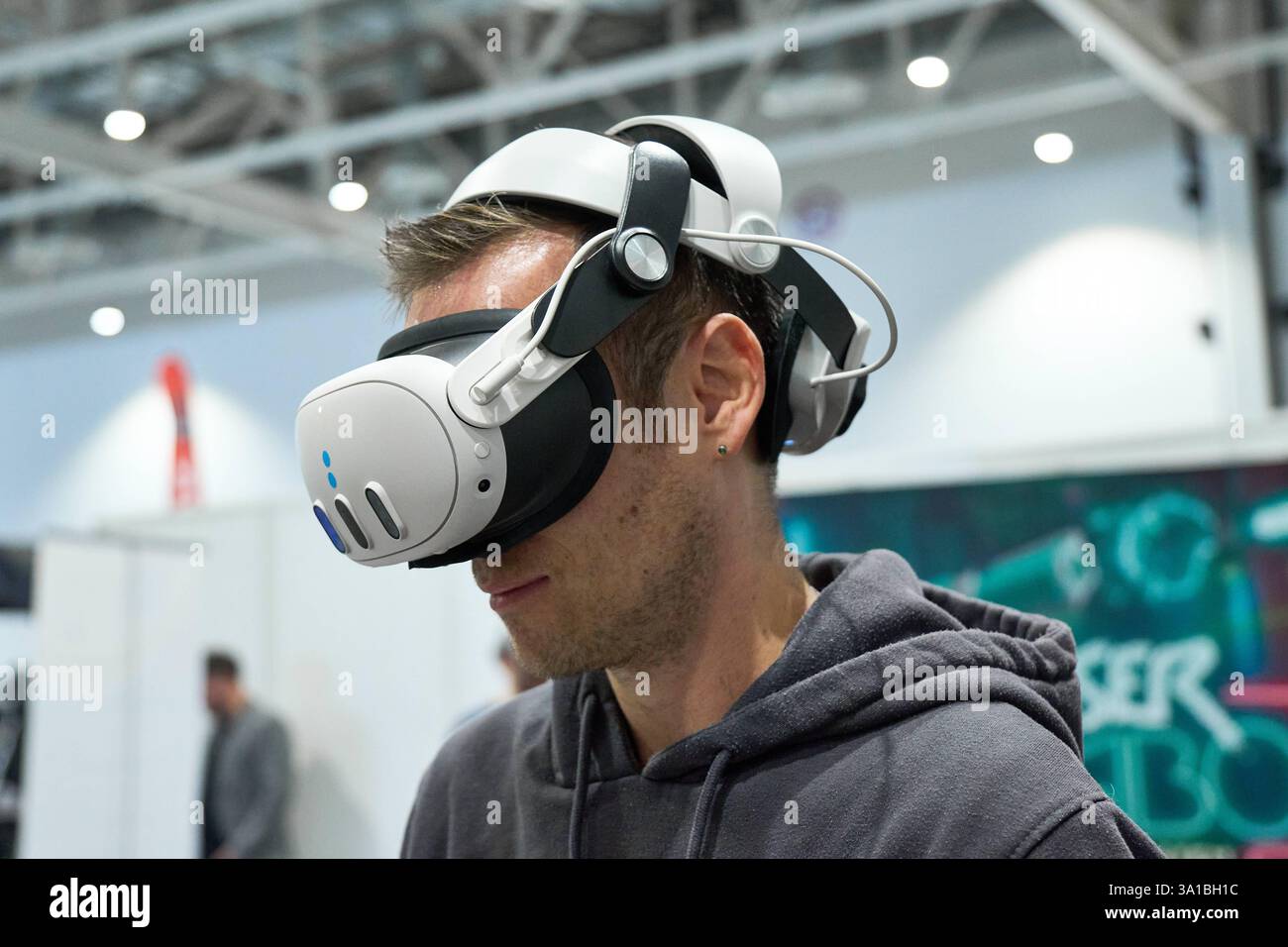 Augsburg, Bavaria, Germany - March 7, 2025: A person wearing modern VR glasses immerses ...