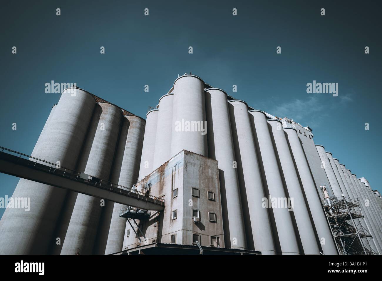A large industrial grain silo facility with multiple tall, cylindrical ...