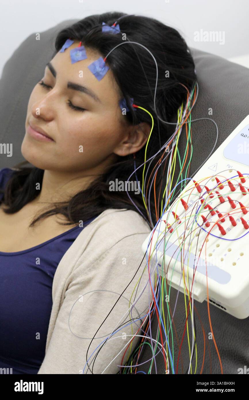 20-year-old Latin brunette woman undergoes EEG electroencephalogram neurological examination ...