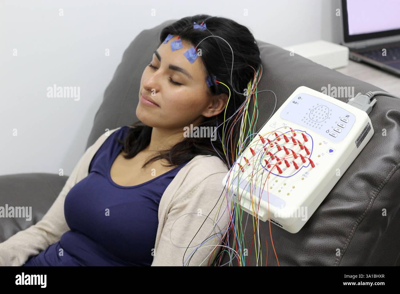 20-year-old Latin brunette woman undergoes EEG electroencephalogram neurological examination ...