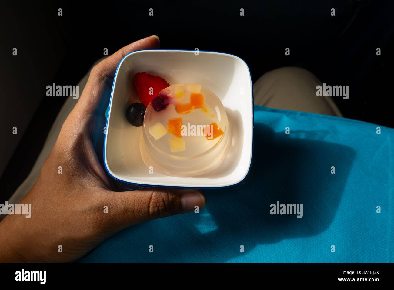 in flight healthy dessert, serving assorted fruit pudding, put on blue ...