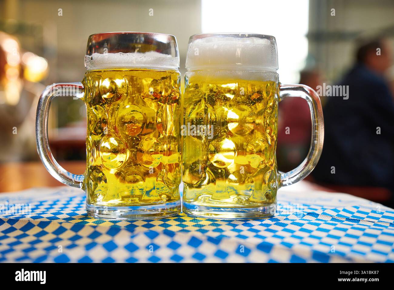 Augsburg, Bavaria, Germany - March 7, 2025: Two filled beer mugs stand ...