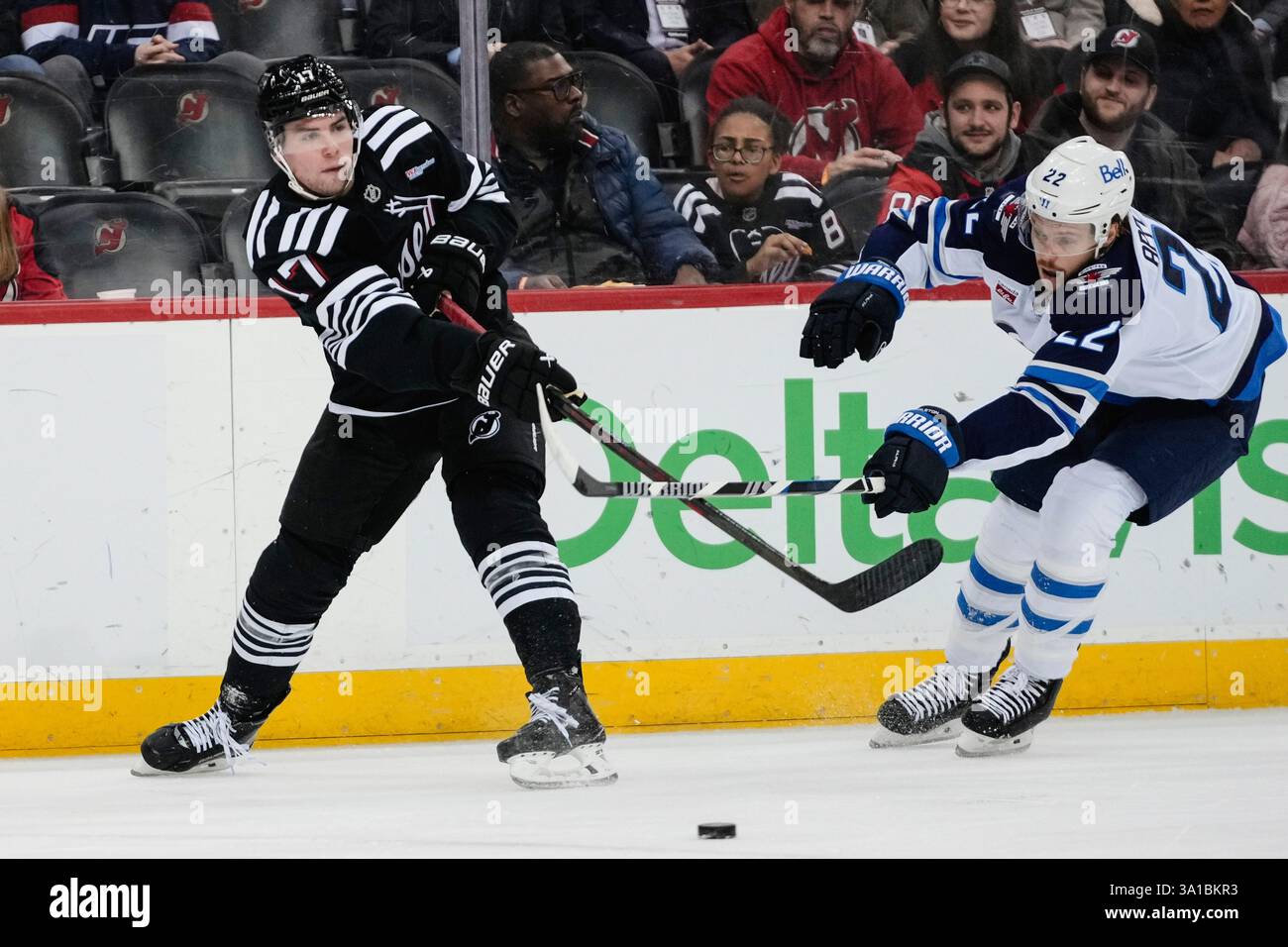 Winnipeg Jets' Mason Appleton (22) fights for control of the puck with ...
