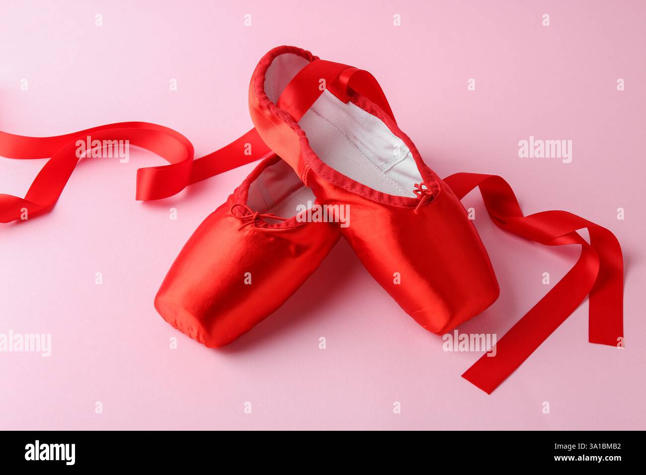 Pair of beautiful red pointe shoes on pink background Stock Photo - Alamy