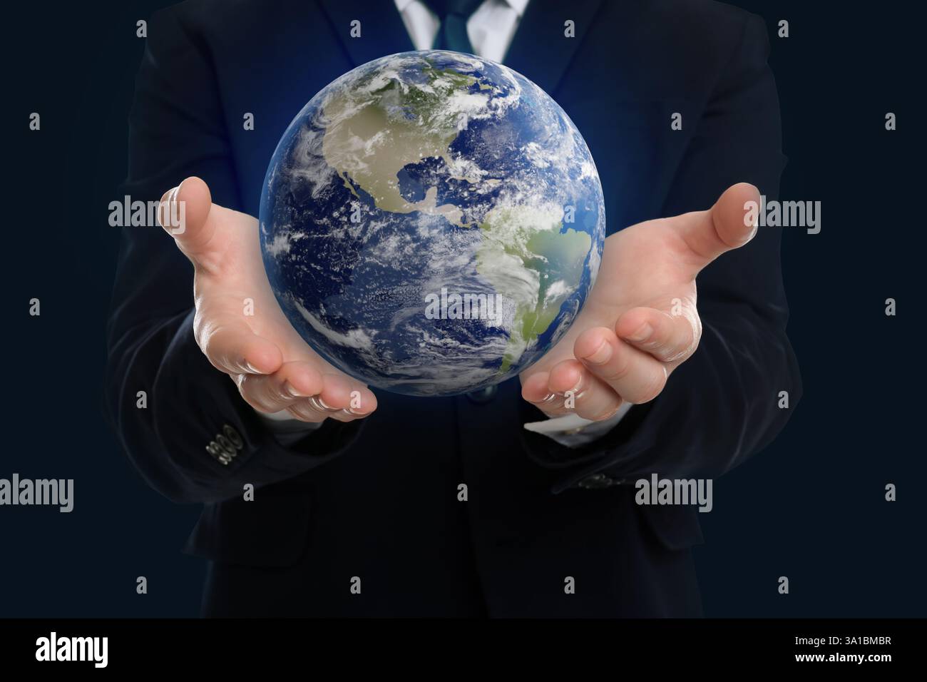 Planet in our hands. Man holding Earth model on dark blue background ...