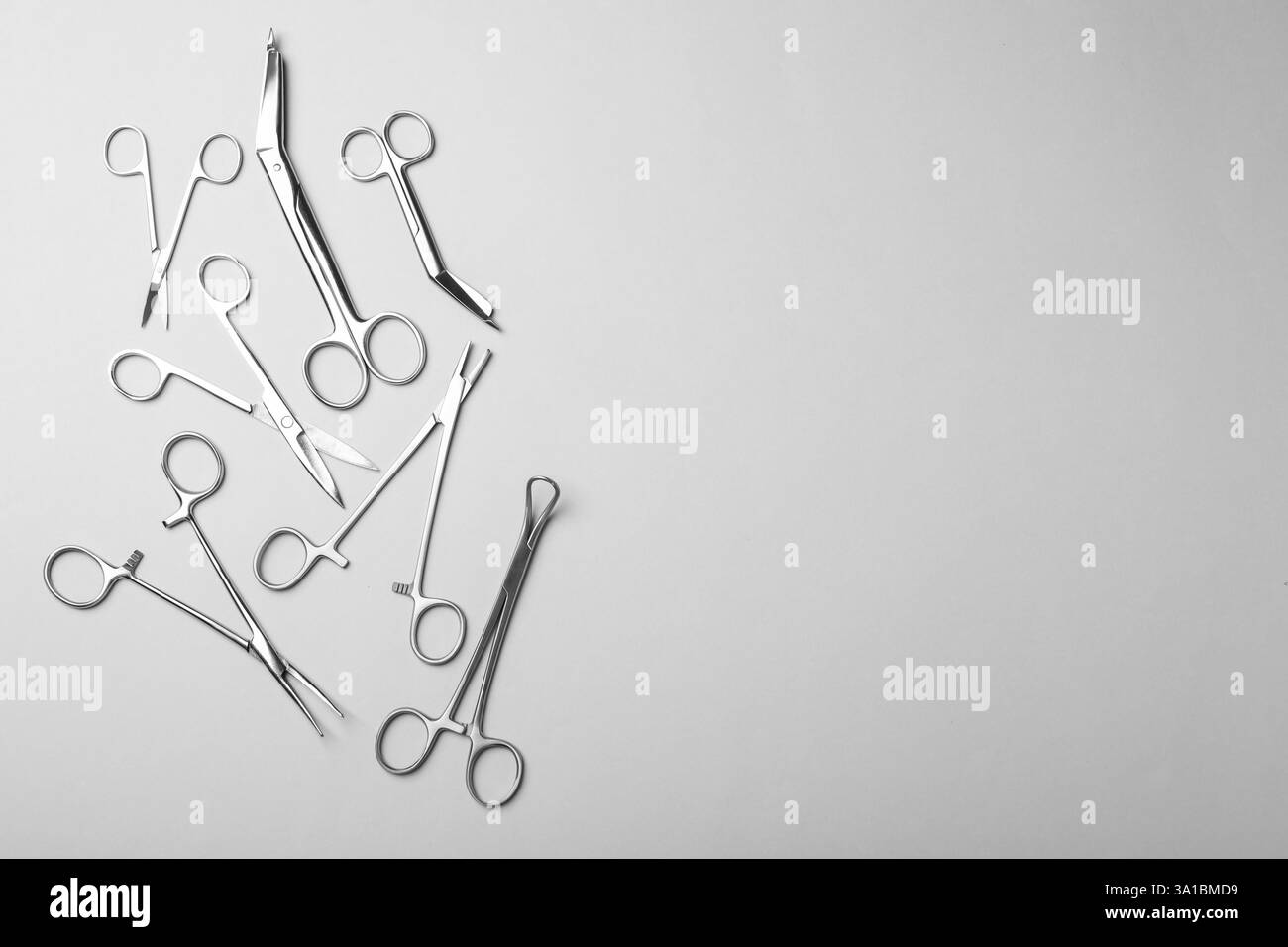 Different surgical instruments on grey background, flat lay. Space for ...