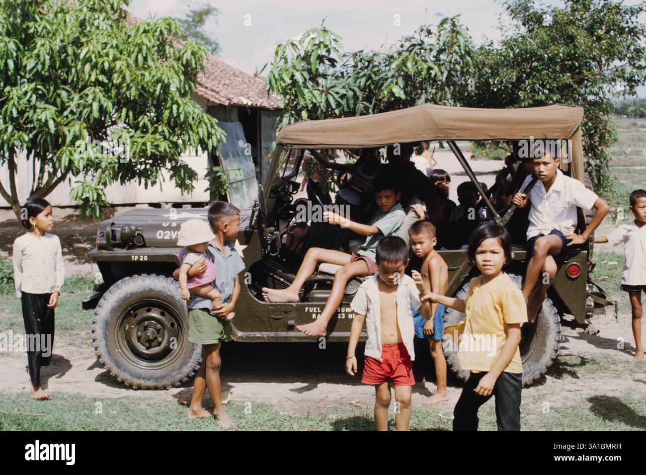 Vietnamese children play on U.S. Army jeep in Vietnam, 1970 Stock Photo ...