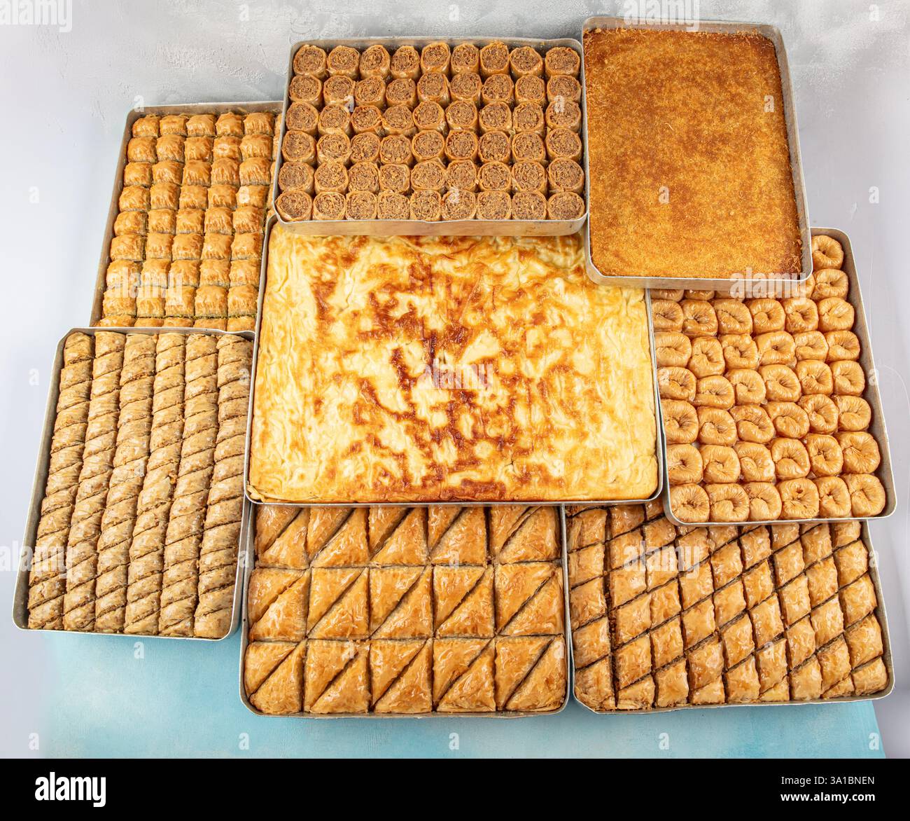 Mixed baklava varieties lined up on trays and tray water borek ...