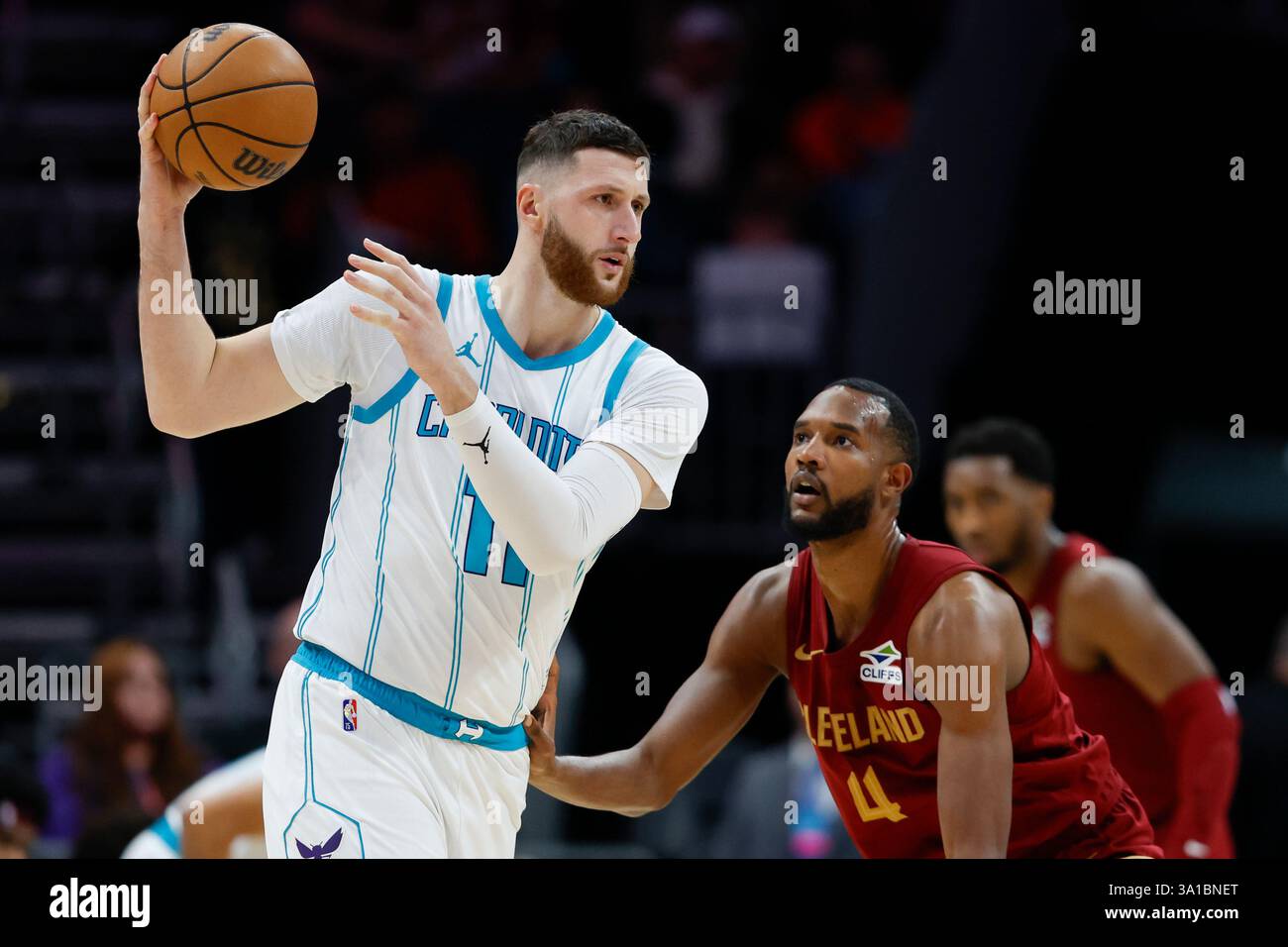 Charlotte Hornets center Jusuf Nurkic, left, looks to pass against ...