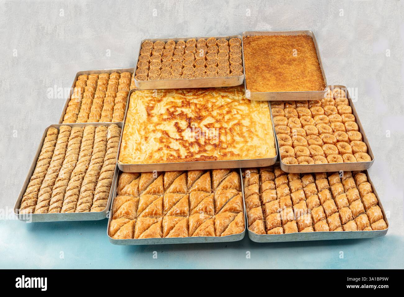 Mixed baklava varieties lined up on trays and tray water borek ...