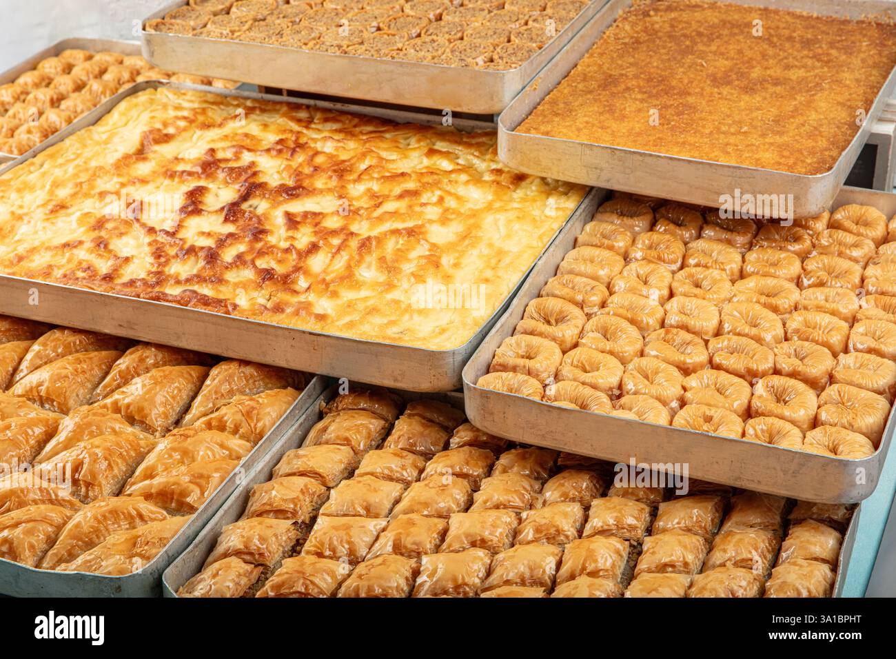 Mixed baklava varieties lined up on trays and tray water borek ...