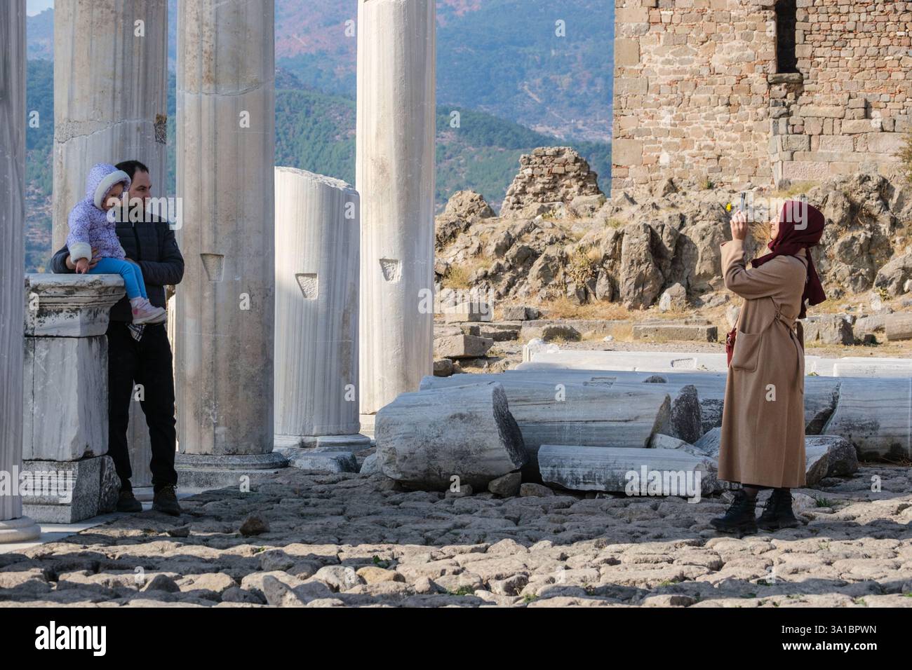 Pergamon, Turkey, Turkiye. Turkish Mother Photographing Father and Daughter, Temple of Trajan, A ...