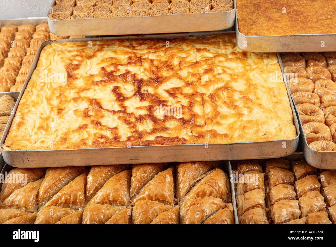 Mixed baklava varieties lined up on trays and tray water borek ...