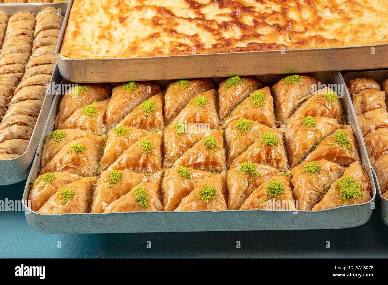 Mixed baklava varieties lined up on trays and tray water borek ...