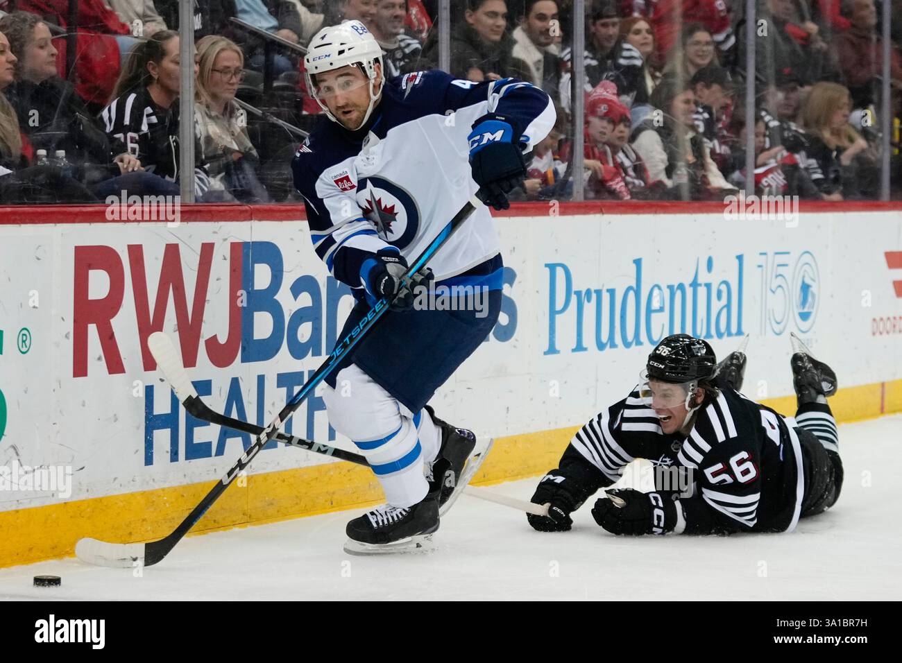 New Jersey Devils' Brenden Dillon (5) fights for control of the puck ...