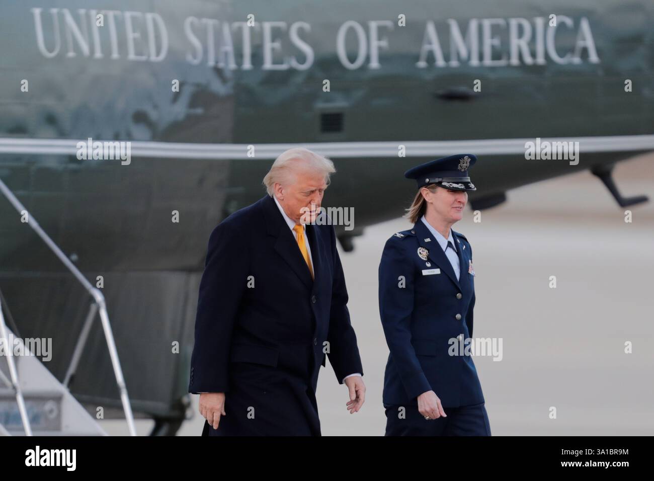 President Donald Trump is escorted by Air Force Col. Angela F. Ochoa ...