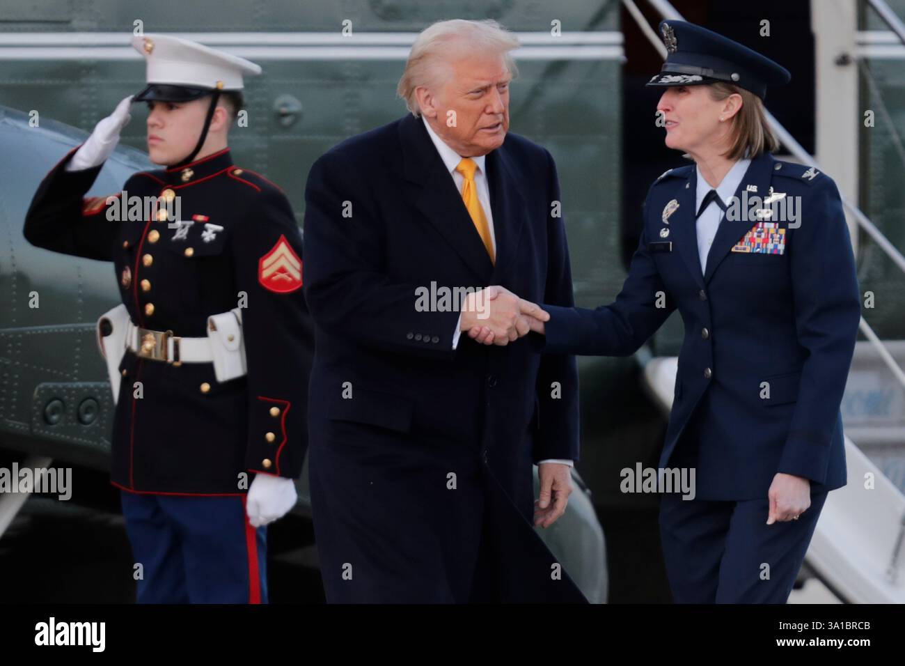 President Donald Trump, center, is greeted by Air Force Col. Angela F ...