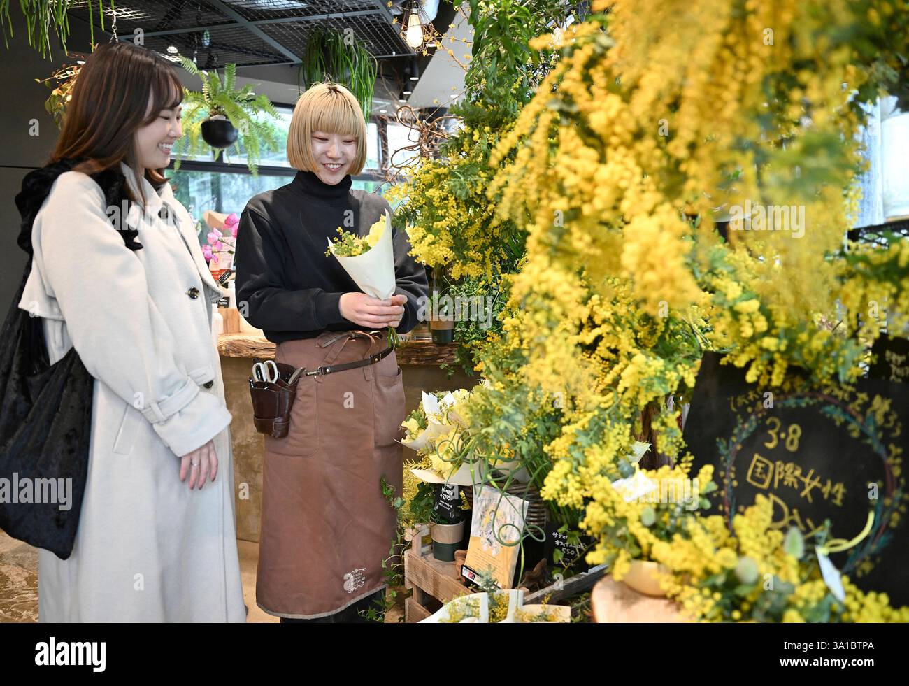 Mimosas line up at a flower shop in Minato Ward, Tokyo on March 8 ...