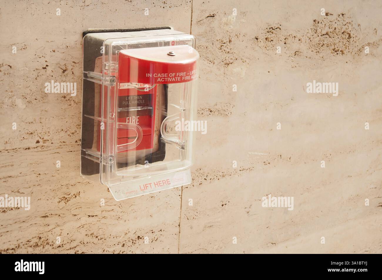 Fire alarm device mounted on wall in public building hallway Stock ...