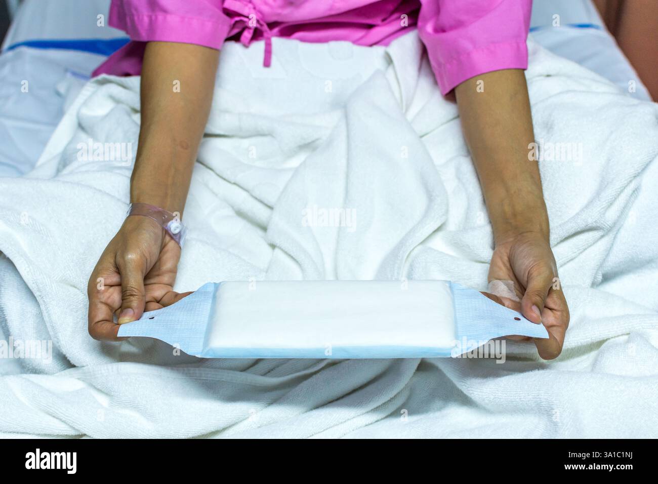 Patient asian woman with adhesive plaster on hand using sanitary napkin ...