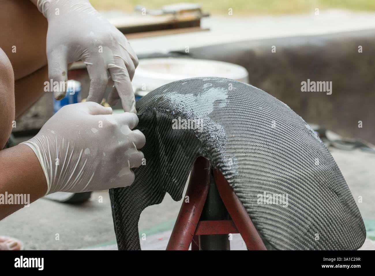 Wrapping carbon fiber or kevlar and man hand for working Stock Photo ...