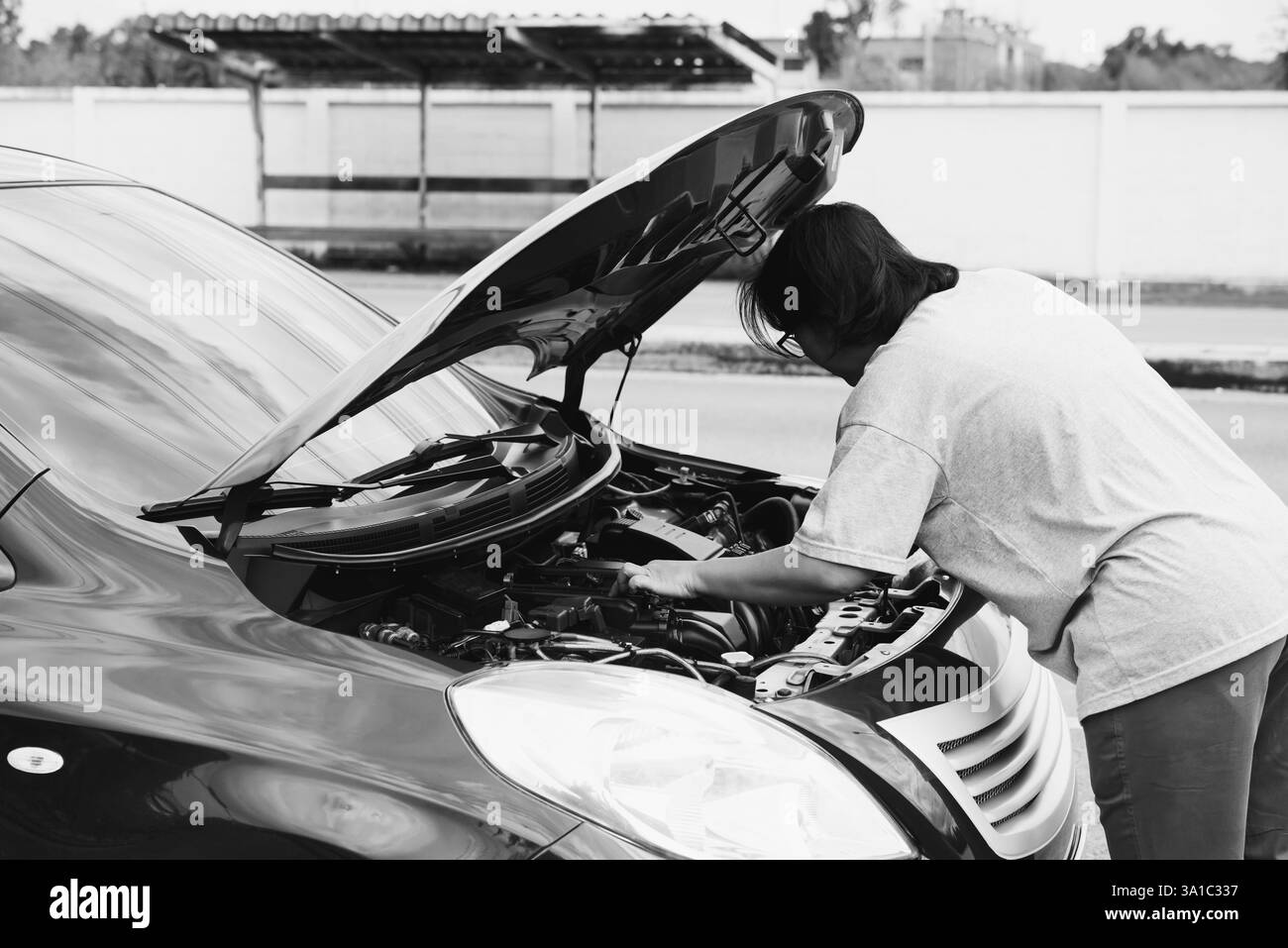 Asian woman 40s alone driver checking a car engine for fix and repair ...