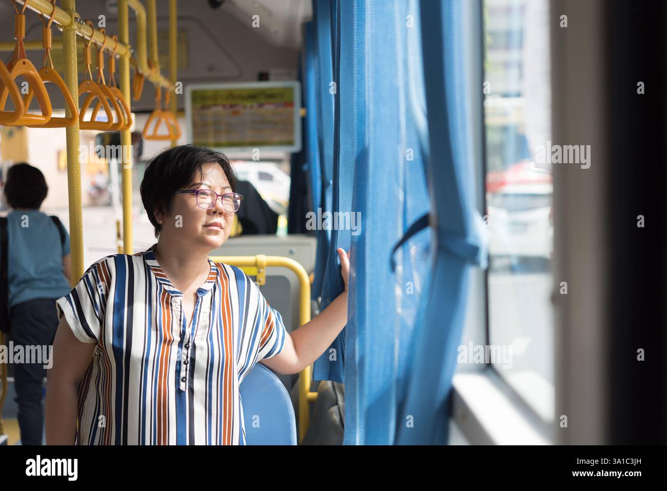 Asian woman 40s people travel by passenger bus in Bangkok city. Buses ...