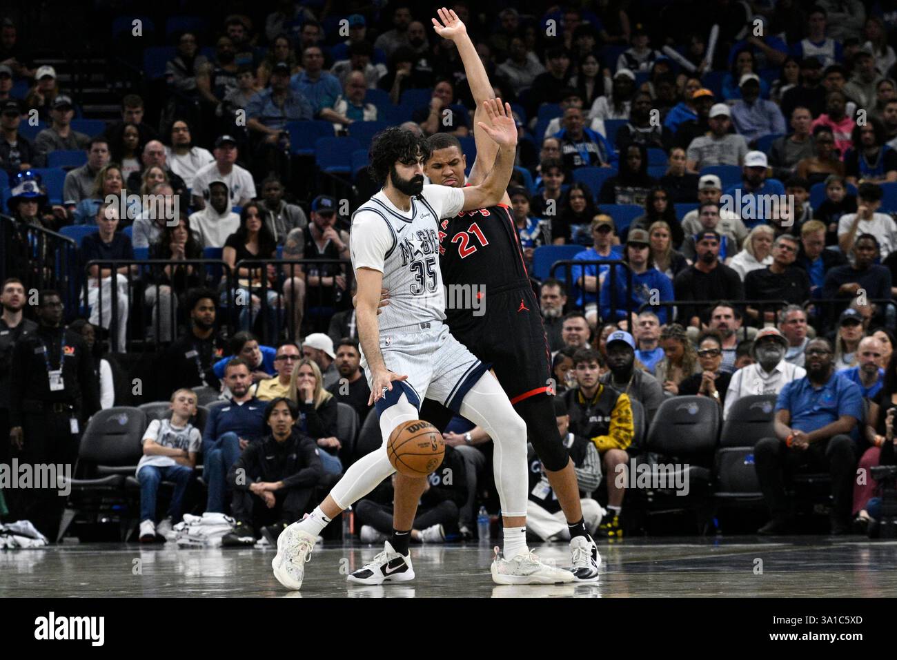 Orlando Magic center Goga Bitadze (35) is defended by Toronto Raptors ...