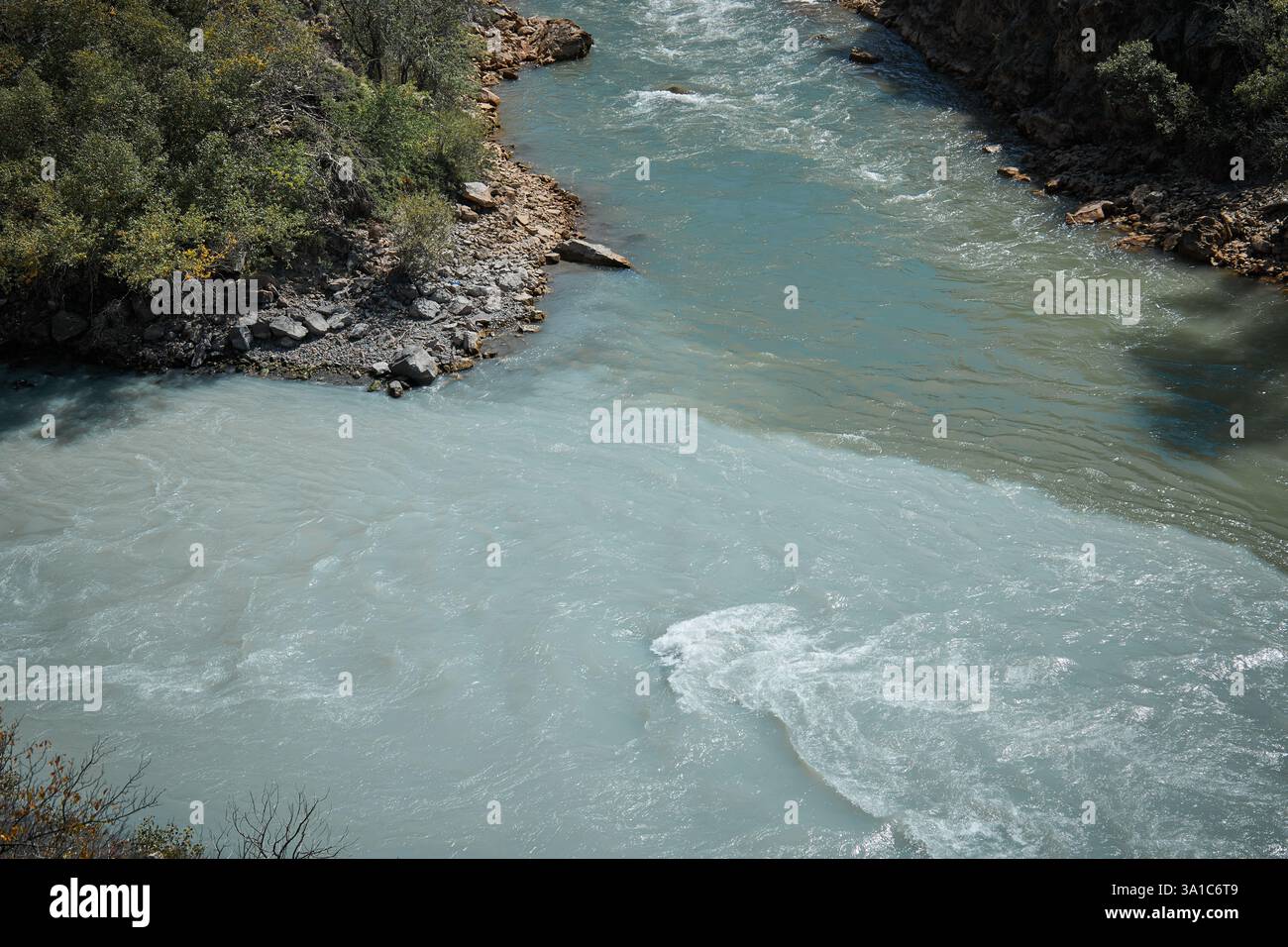 confluence of two rivers of different colors, emerald green and ...
