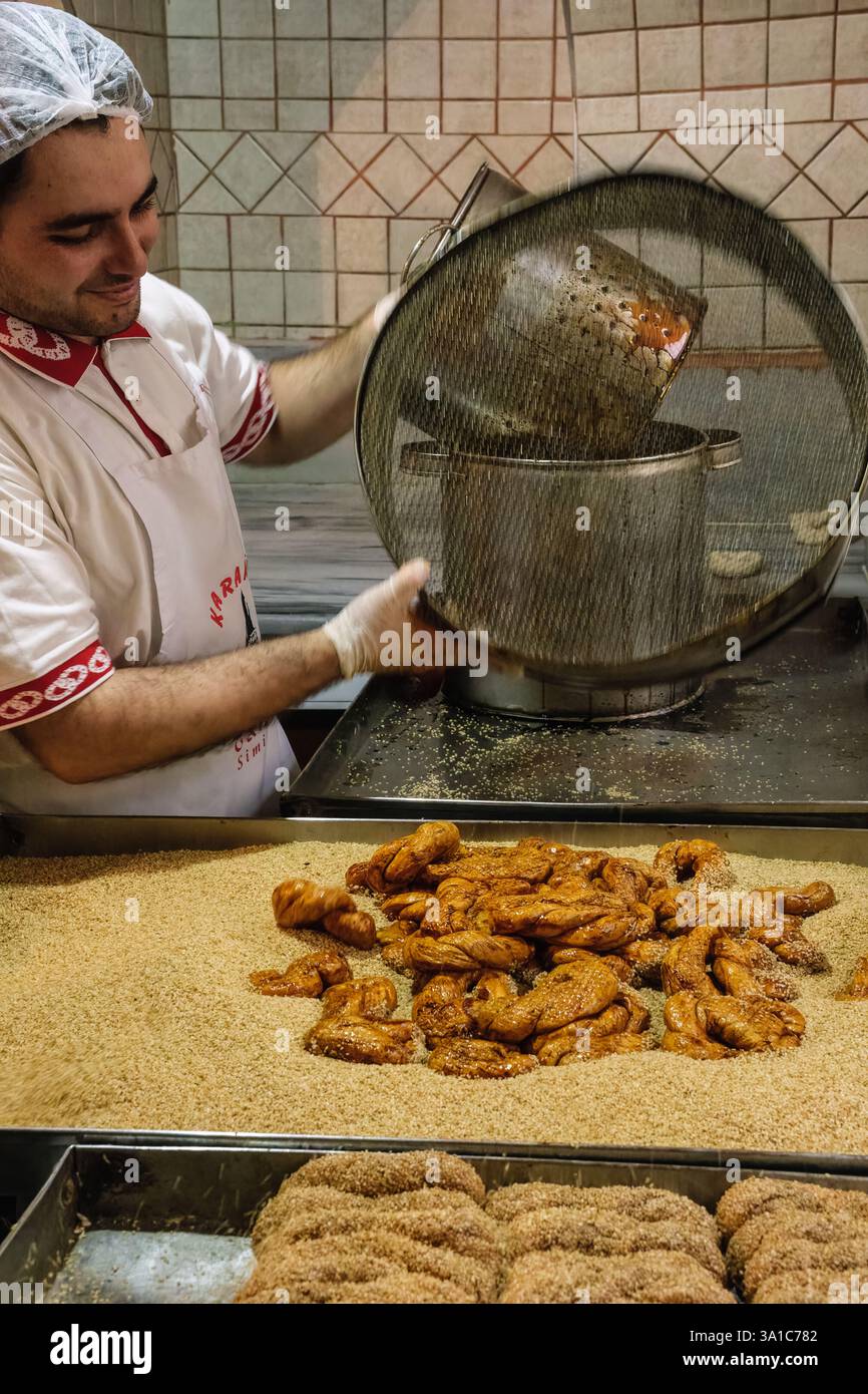 Istanbul, Turkey, Turkiye. Baker Pouring Molasses-covered Simit ...