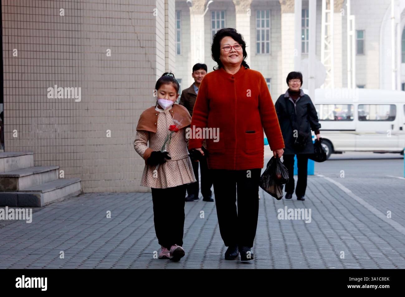 Pyongyang citizens walk in the street of the Pyongyang railway station ...