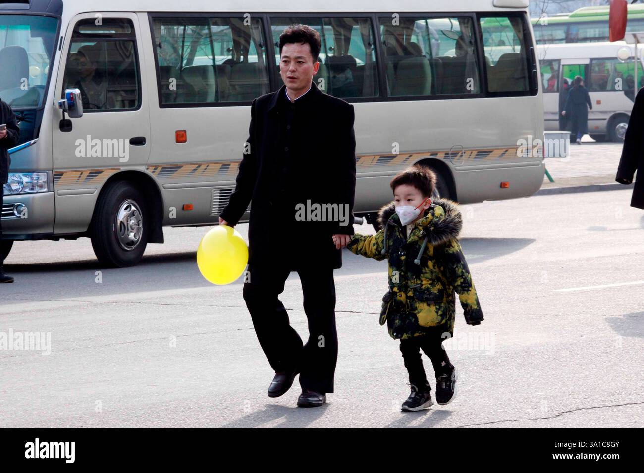 Pyongyang citizens walk in the street of the Pyongyang railway station ...