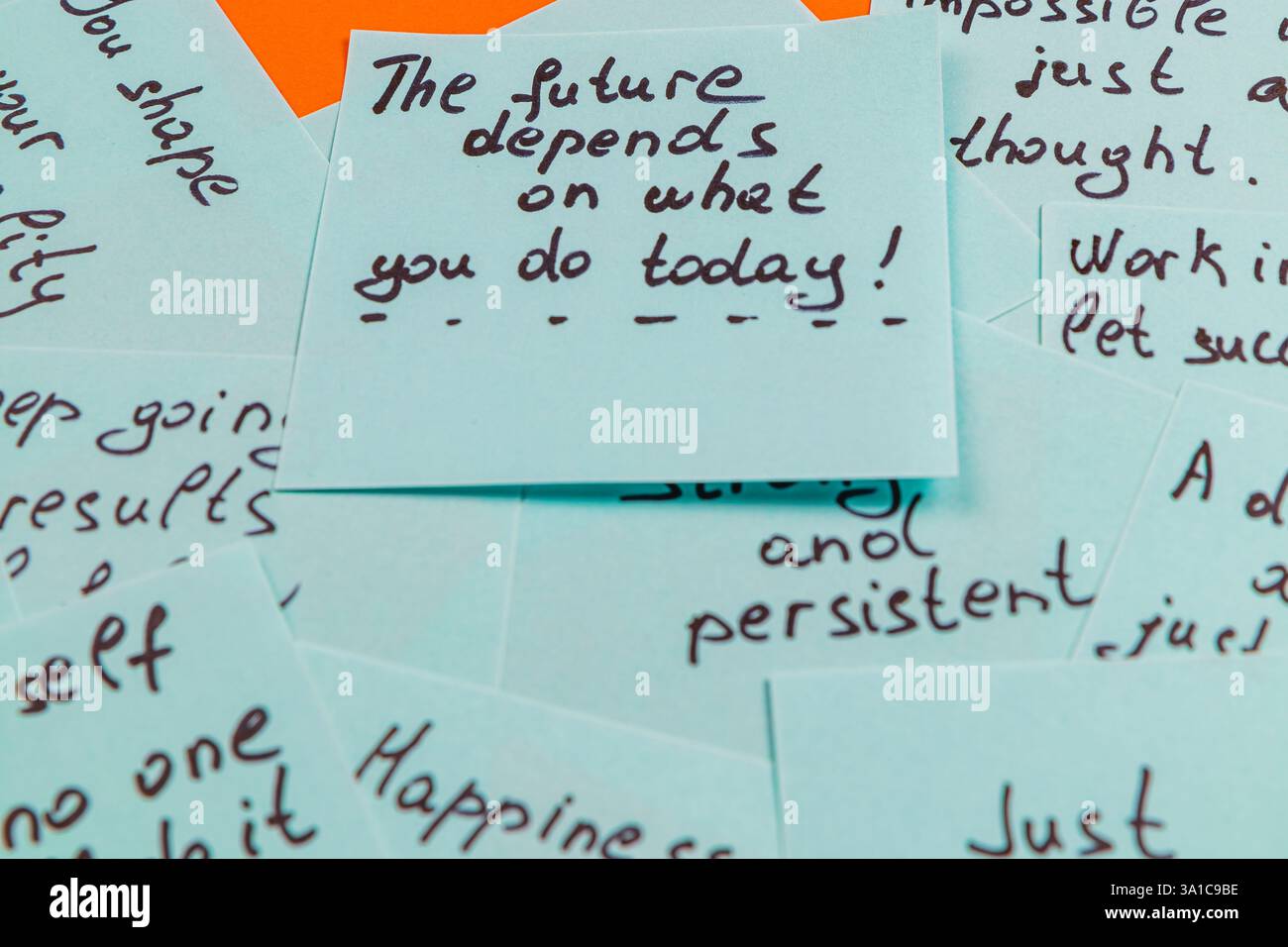 Colorful sticky notes filled with motivational quotes are scattered on ...