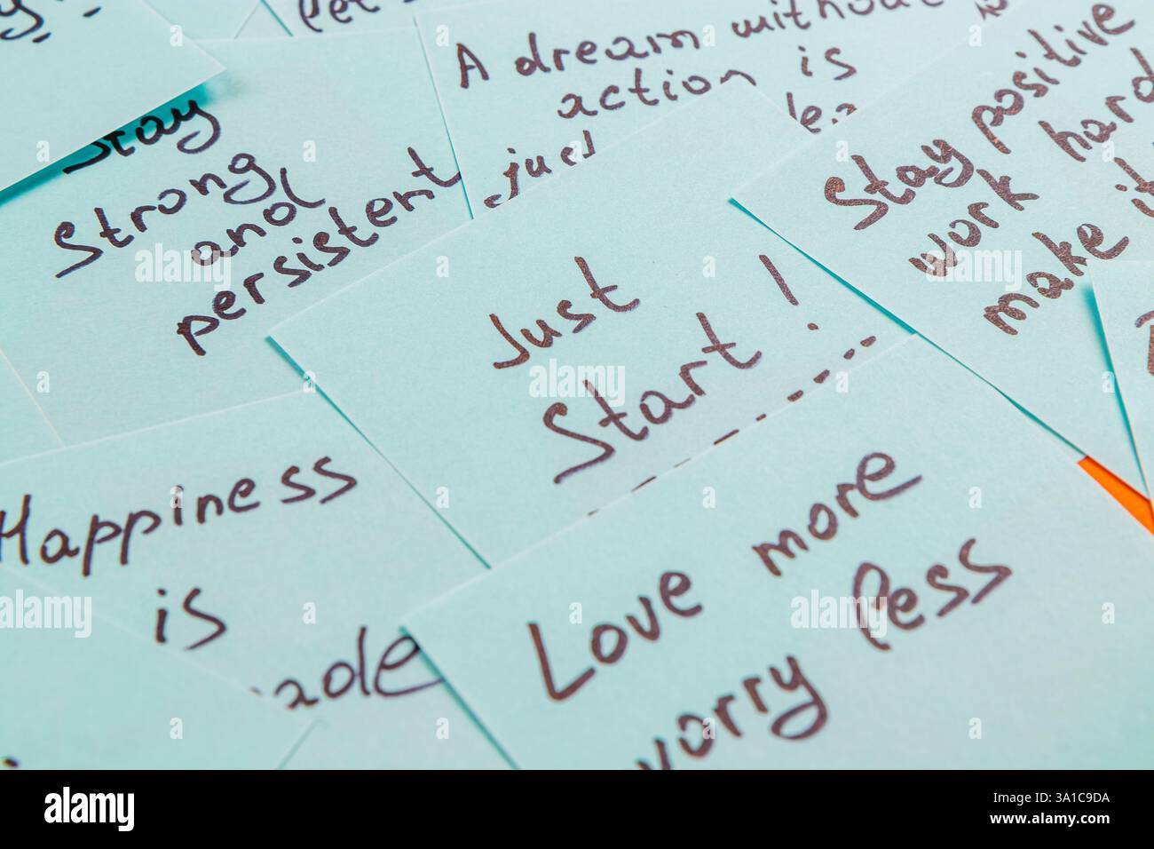 Various paper cards featuring handwritten motivational quotes arranged ...