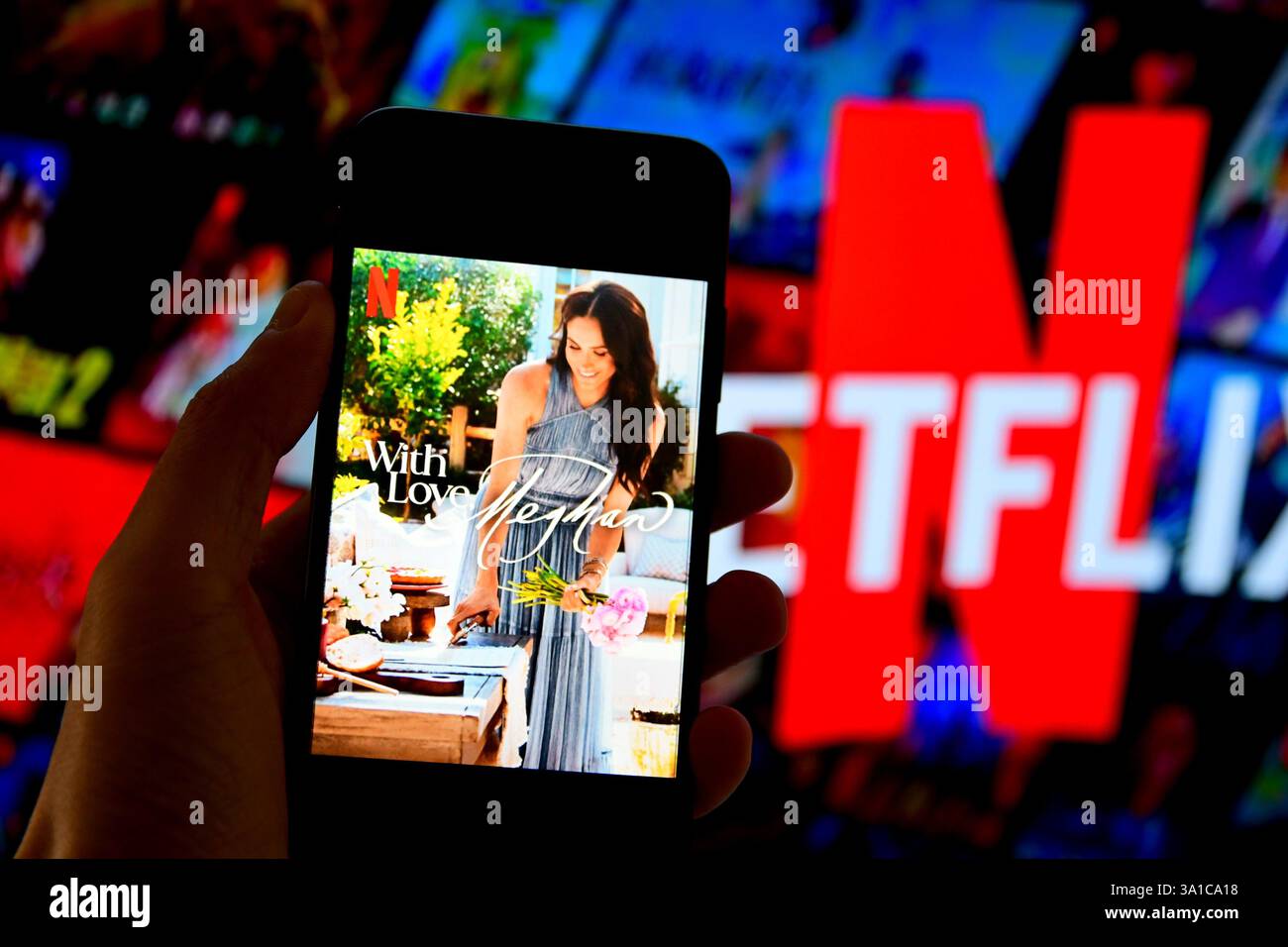 Poster on phone of the series With Love Meghan on Meghan Markle ...