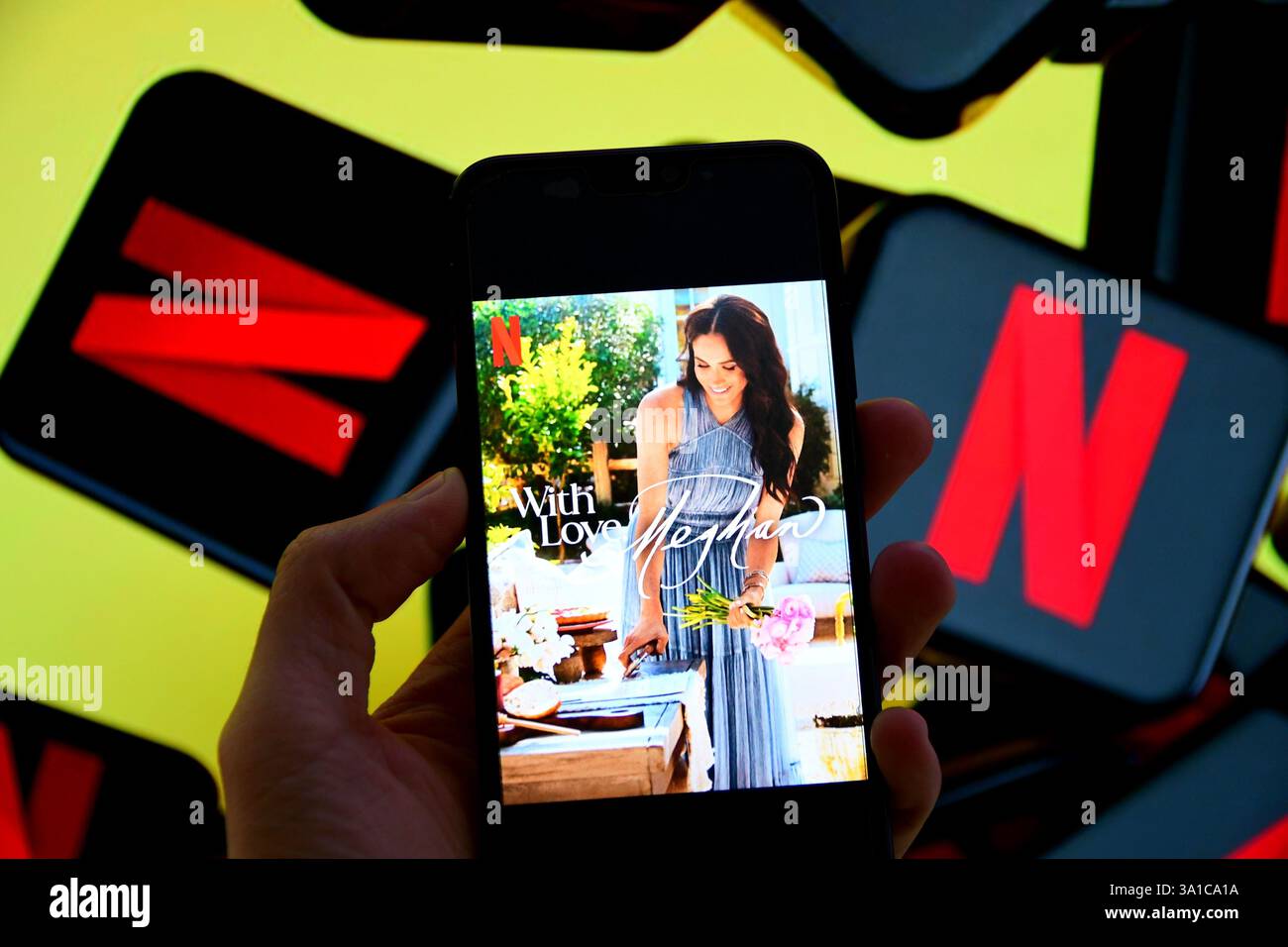 Poster on phone of the series With Love Meghan on Meghan Markle ...