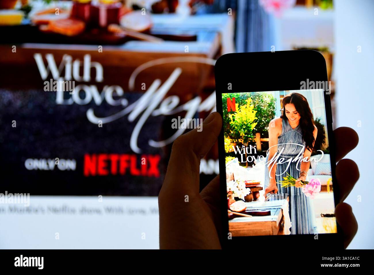 Poster on phone of the series With Love Meghan on Meghan Markle ...