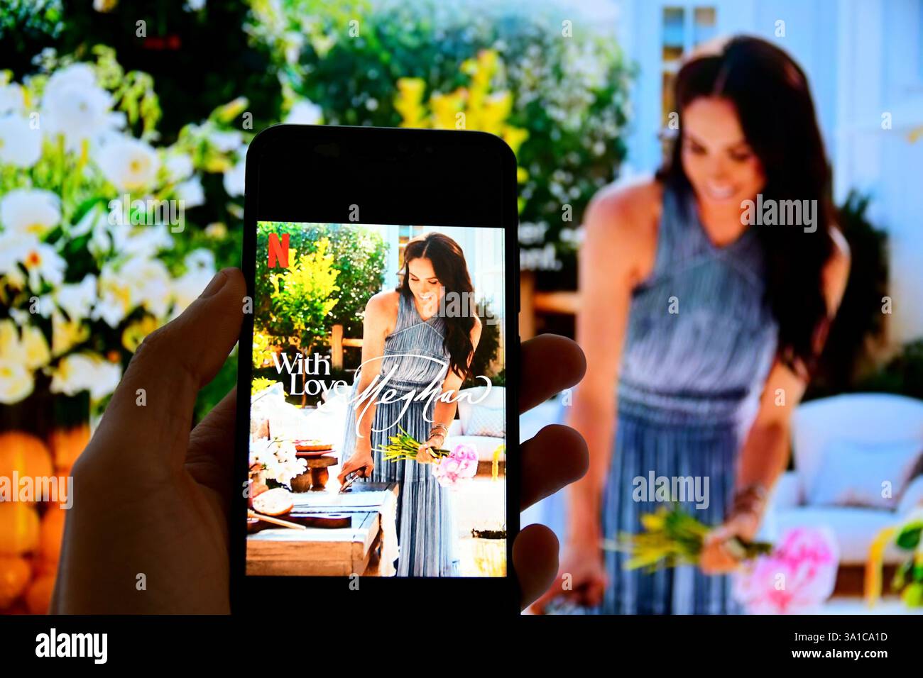 Poster on phone of the series With Love Meghan on Meghan Markle ...