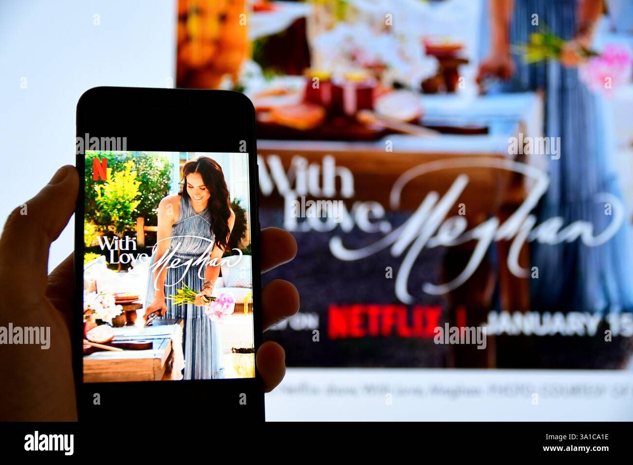 Poster on phone of the series With Love Meghan on Meghan Markle ...
