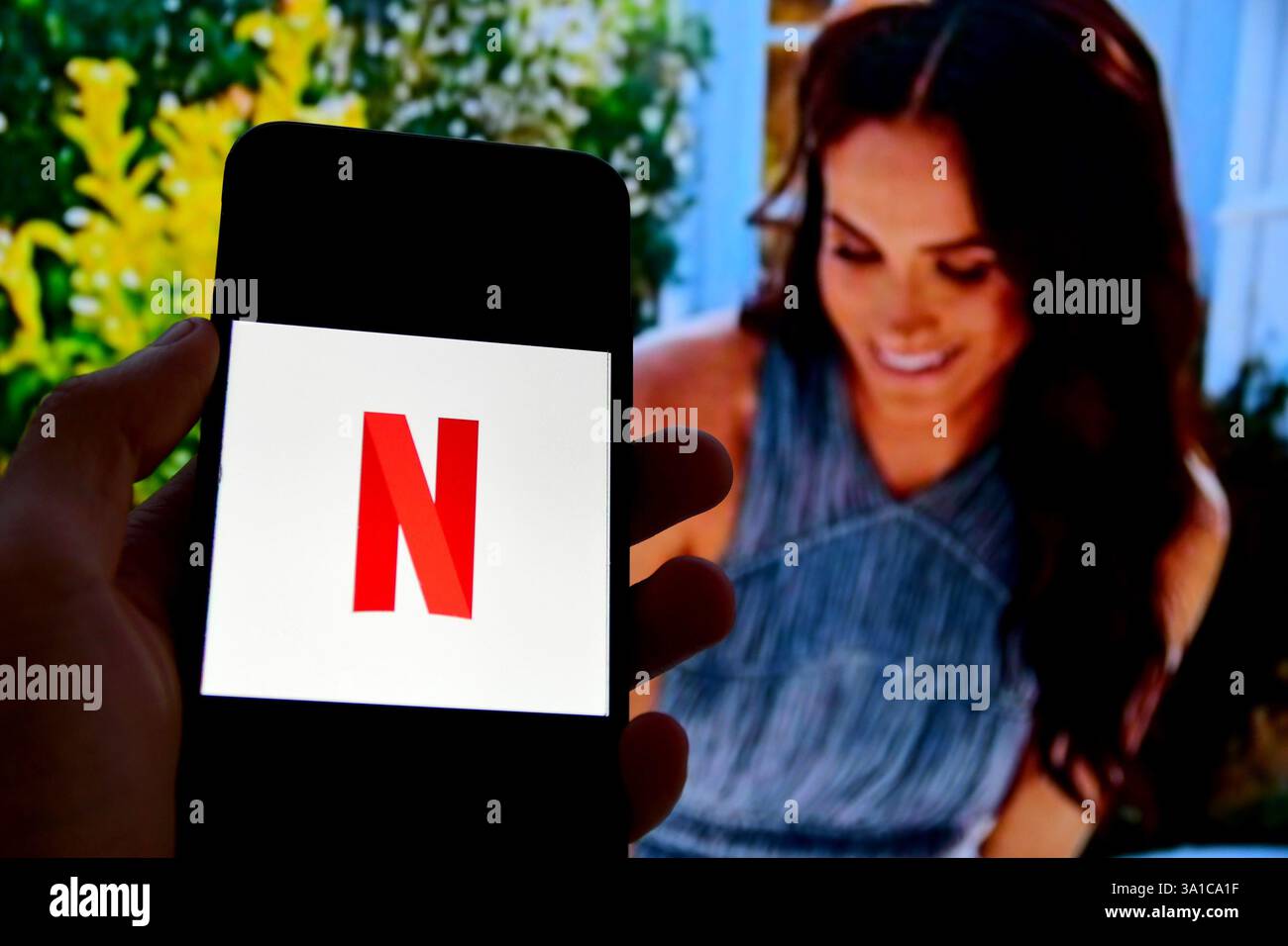 Netflix company on phone with the series With Love Meghan on Meghan ...