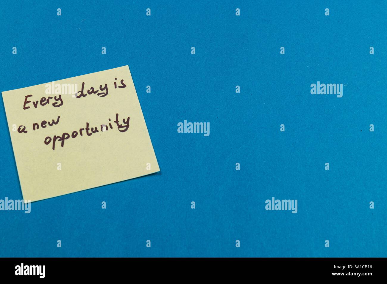 A bright yellow sticky note with handwritten text conveys a ...