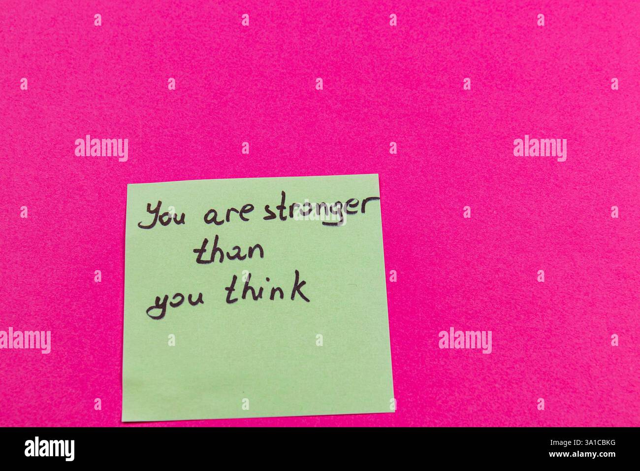 A bright pink background features a green sticky note with the ...