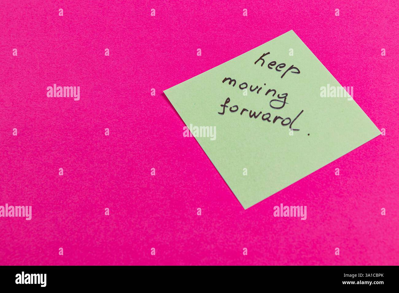 A bright pink background features a green sticky note with the handwritten message to keep ...