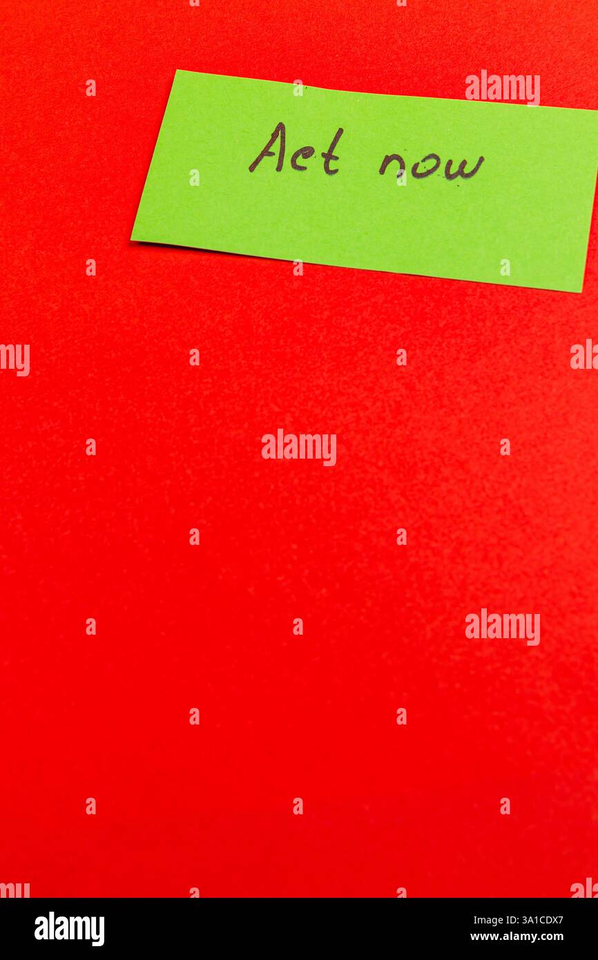 A bright red surface features a green sticky note with the message ...
