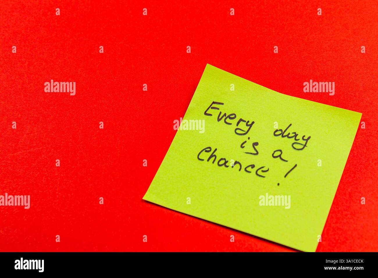 A bright green sticky note features an inspirational message, placed ...