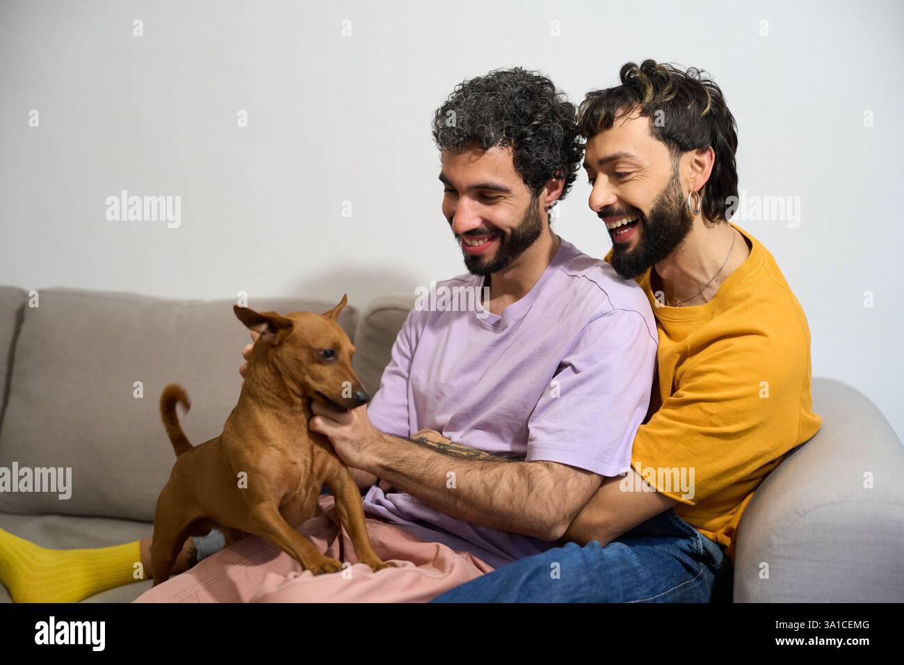 Happy gay couple cuddling on hi-res stock photography and images - Alamy