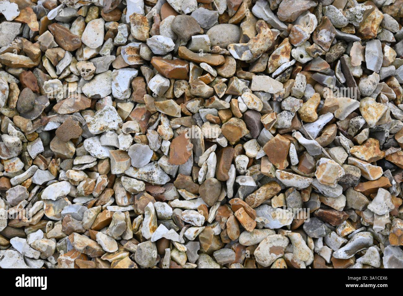 A pile of rocks with some white ones. The rocks are of different sizes ...